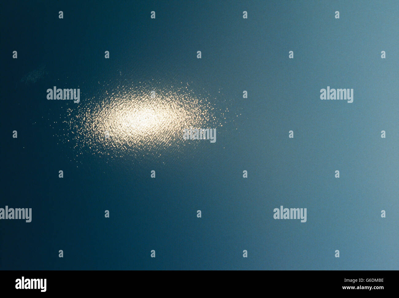 Aerial view of sun reflecting off ripples of water in the Atlantic ...