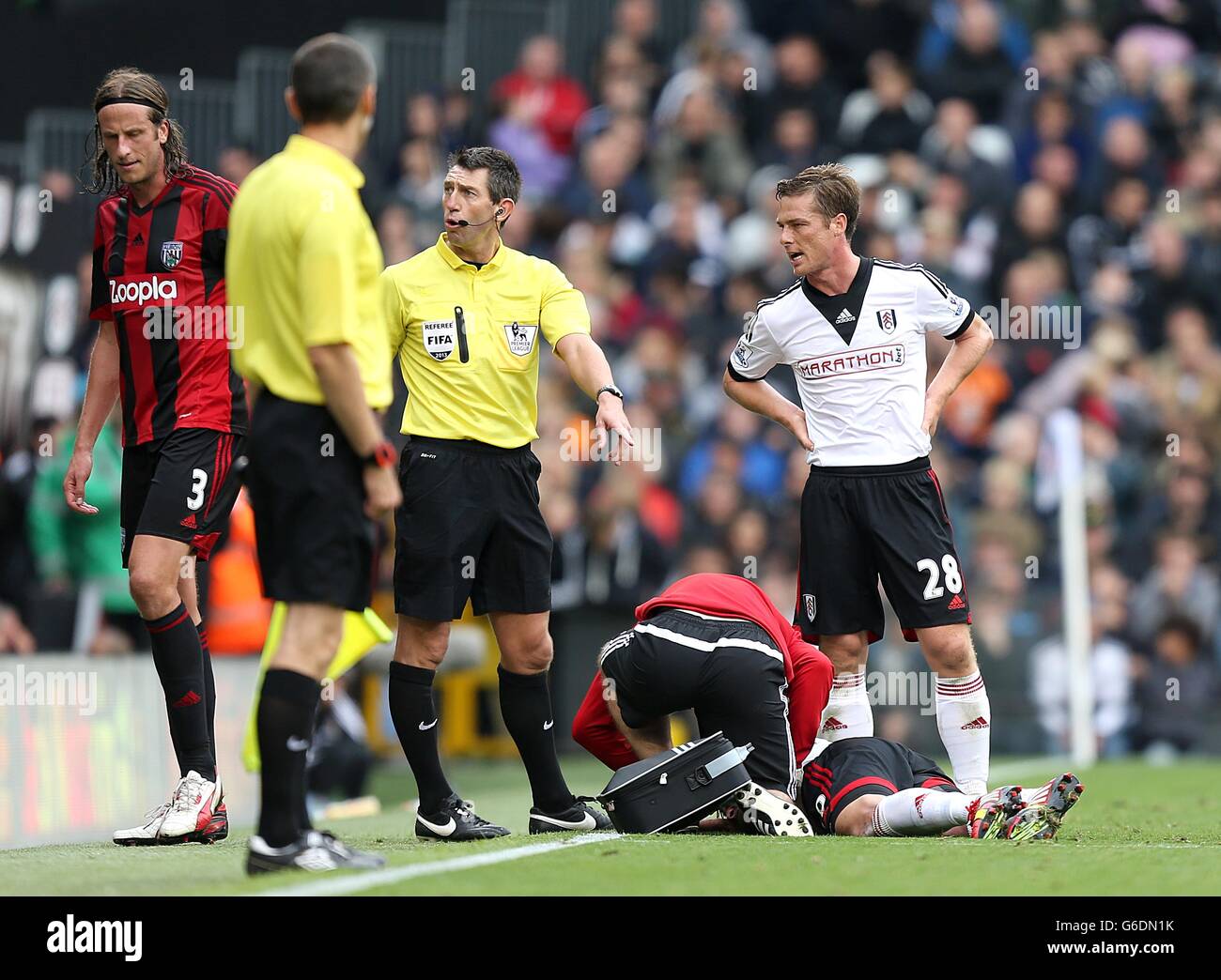 Fulham's Scott Parker (right)speaks with match referee Lee Probert ...