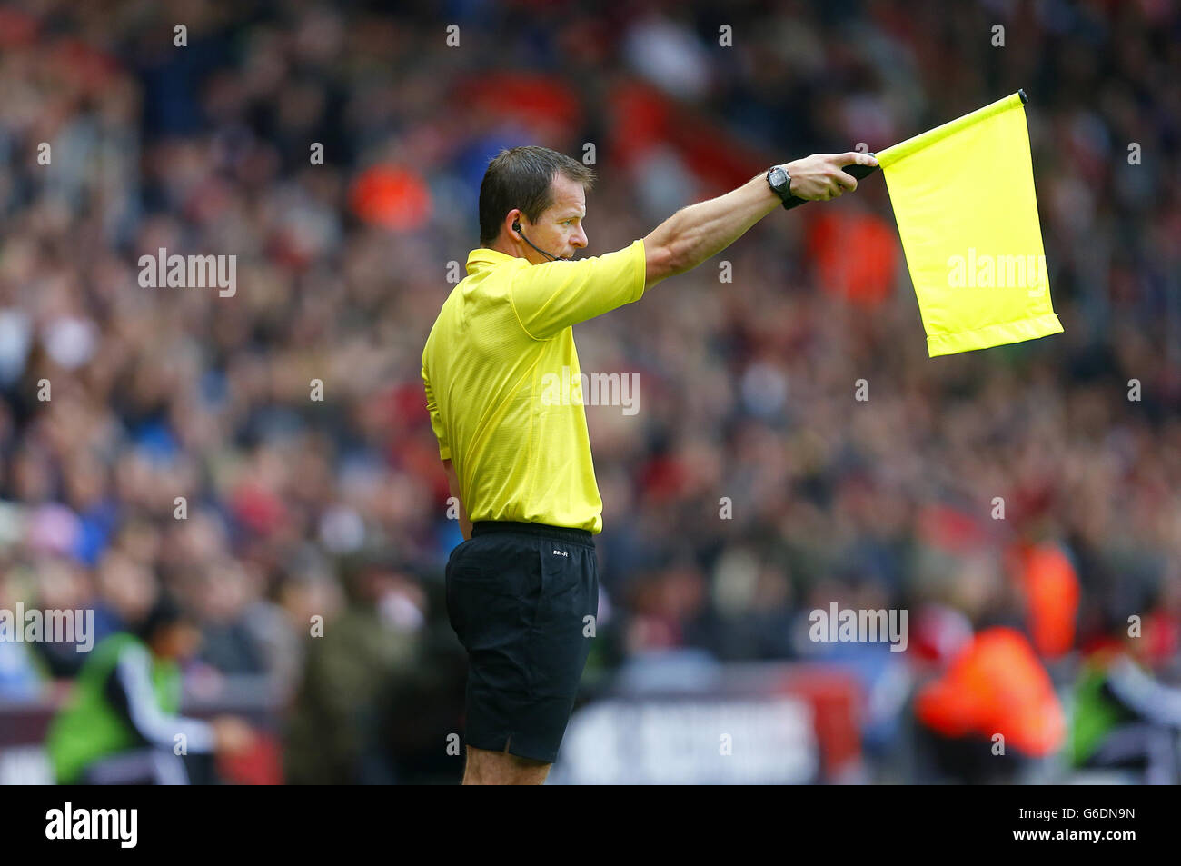 Linesman uses his flag to indicate player is offside hi-res stock ...
