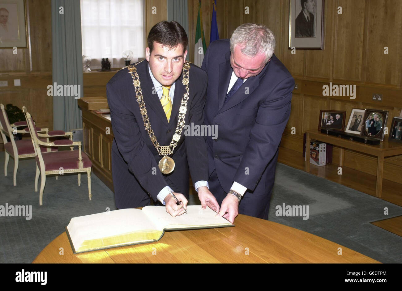 The new Lord Mayor of Dublin, Royston Brady (left) signs the visitors ...
