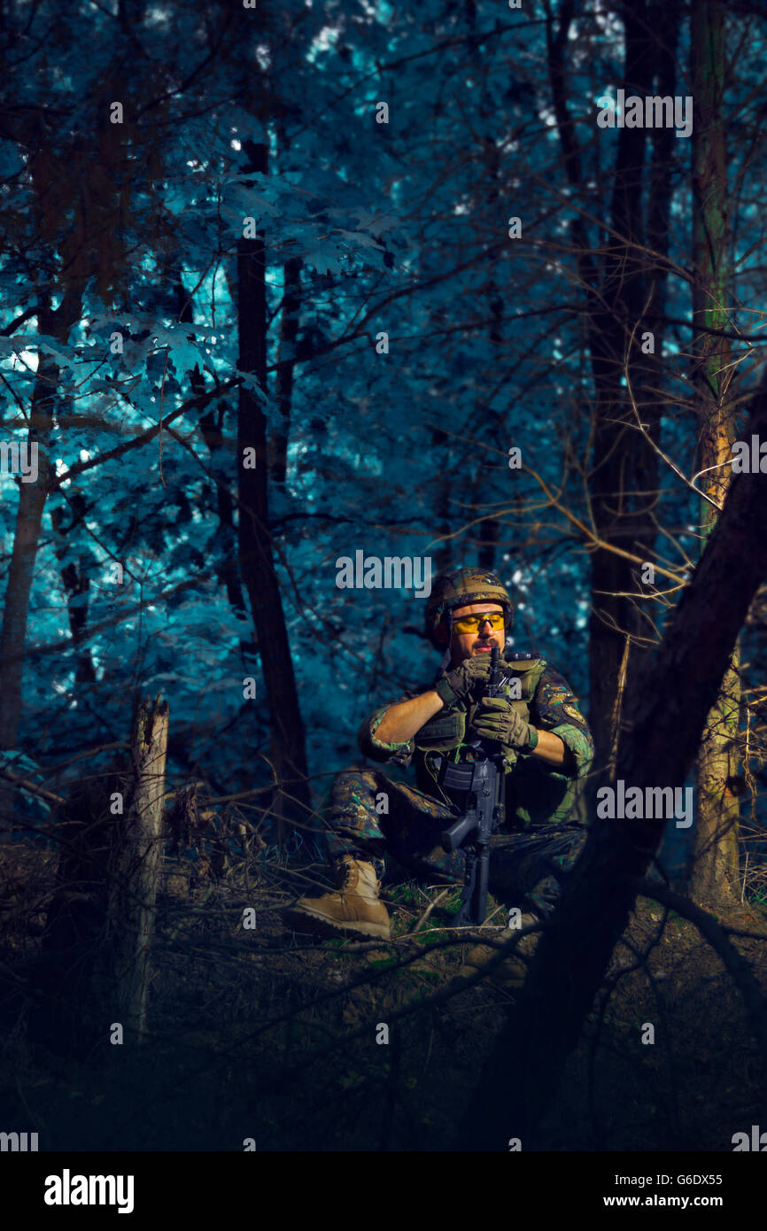 Airsoft soldier sitting in the forest during International competition ...