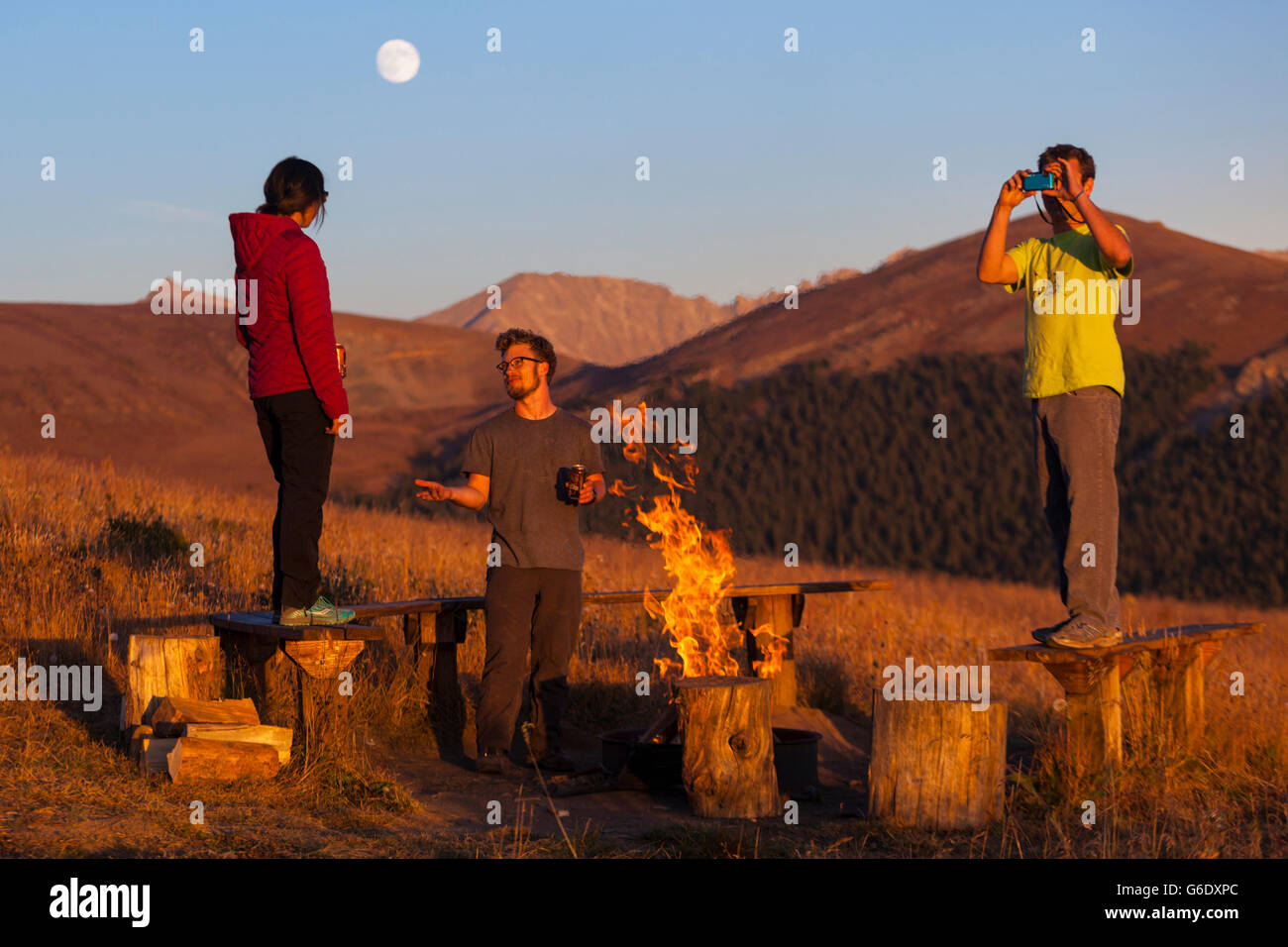 Friends hang out by the campfire outside the Jackal Hut, White River ...