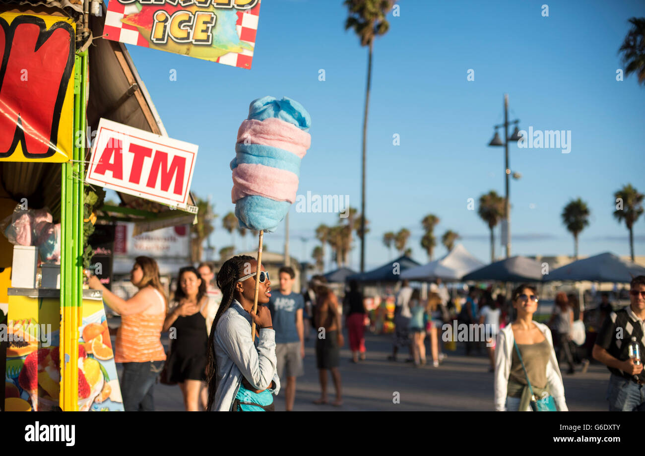 A young woman sells cotton candy on Oceanfront Walk, also known as the ...