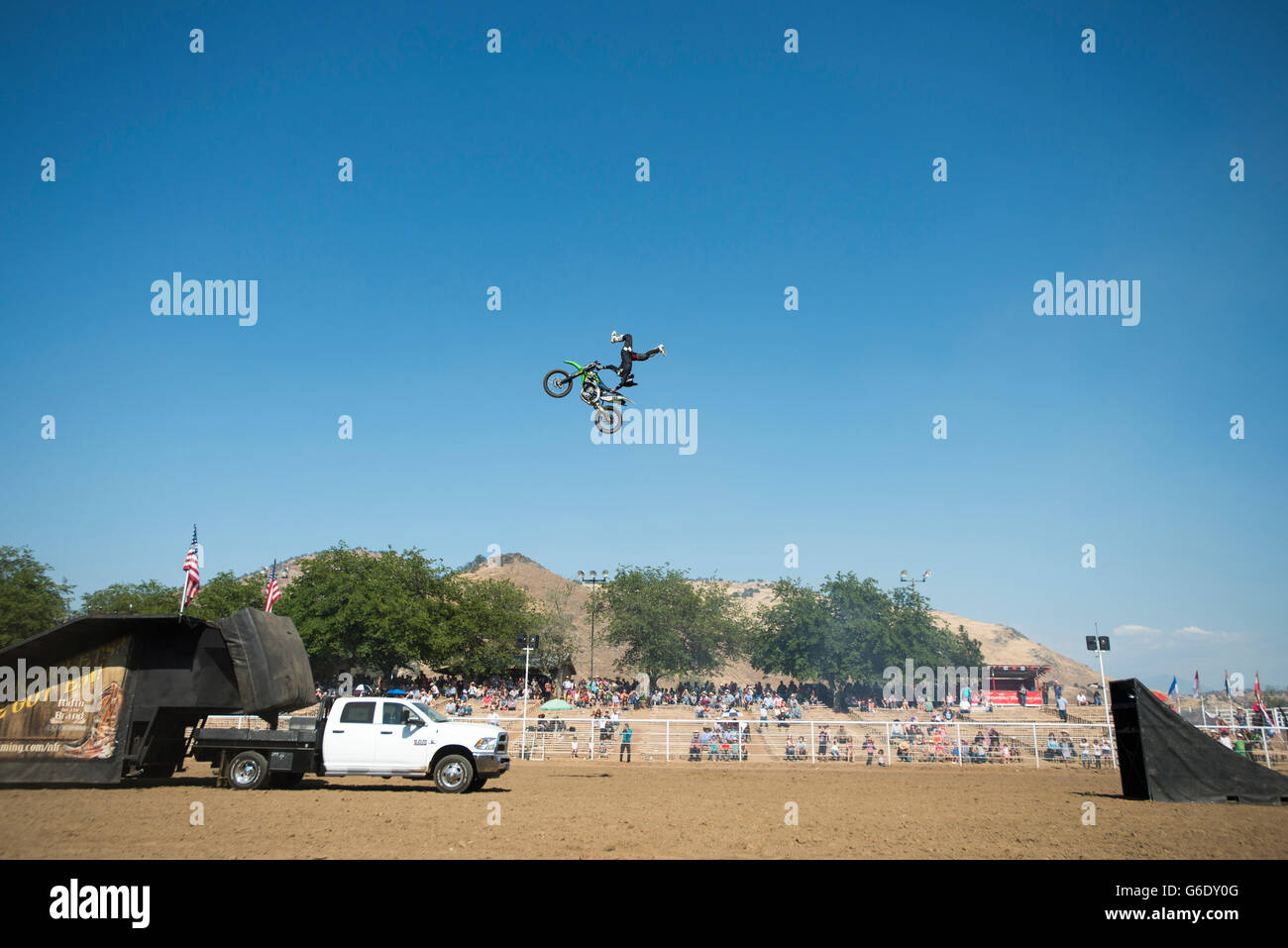 A stunt motocross rider does an aerial maneuver during the finale of ...