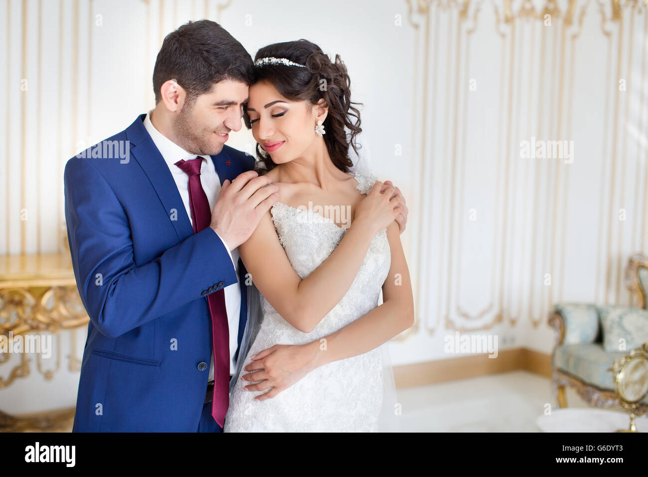 The groom gently embraces and kisses the bride Stock Photo - Alamy