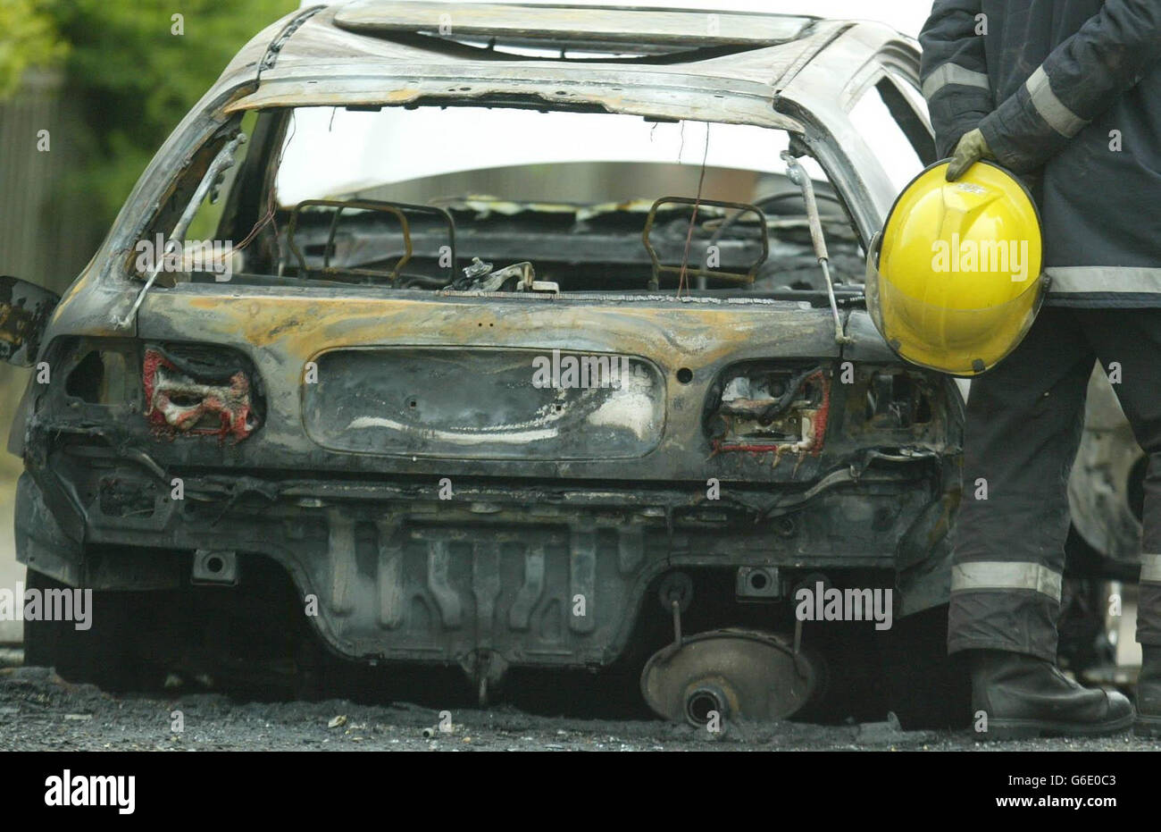 Firemen inspect the scene where a teenager fought desperately to save a ...
