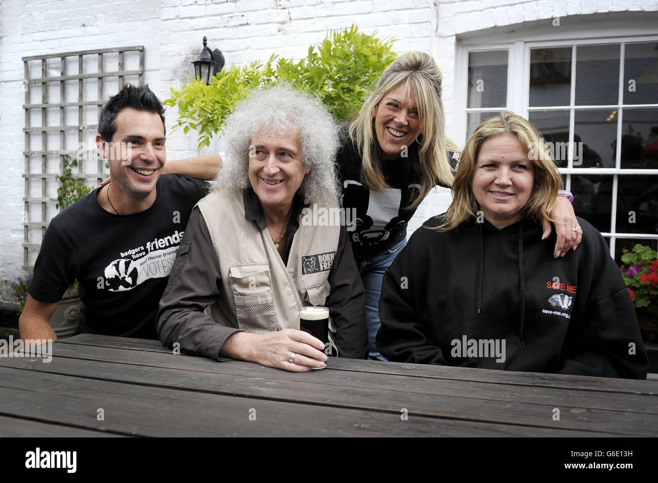 Queen guitarist Brian May (second left)poses for photographers in ...
