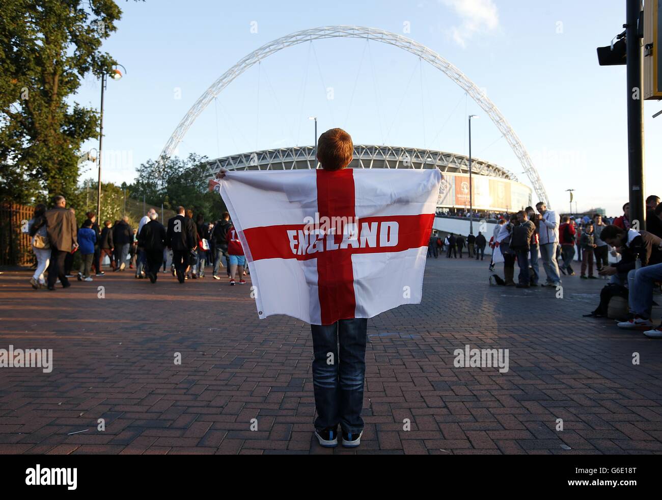 A young England fan poses for a photograph outside Wembley Stadium ...