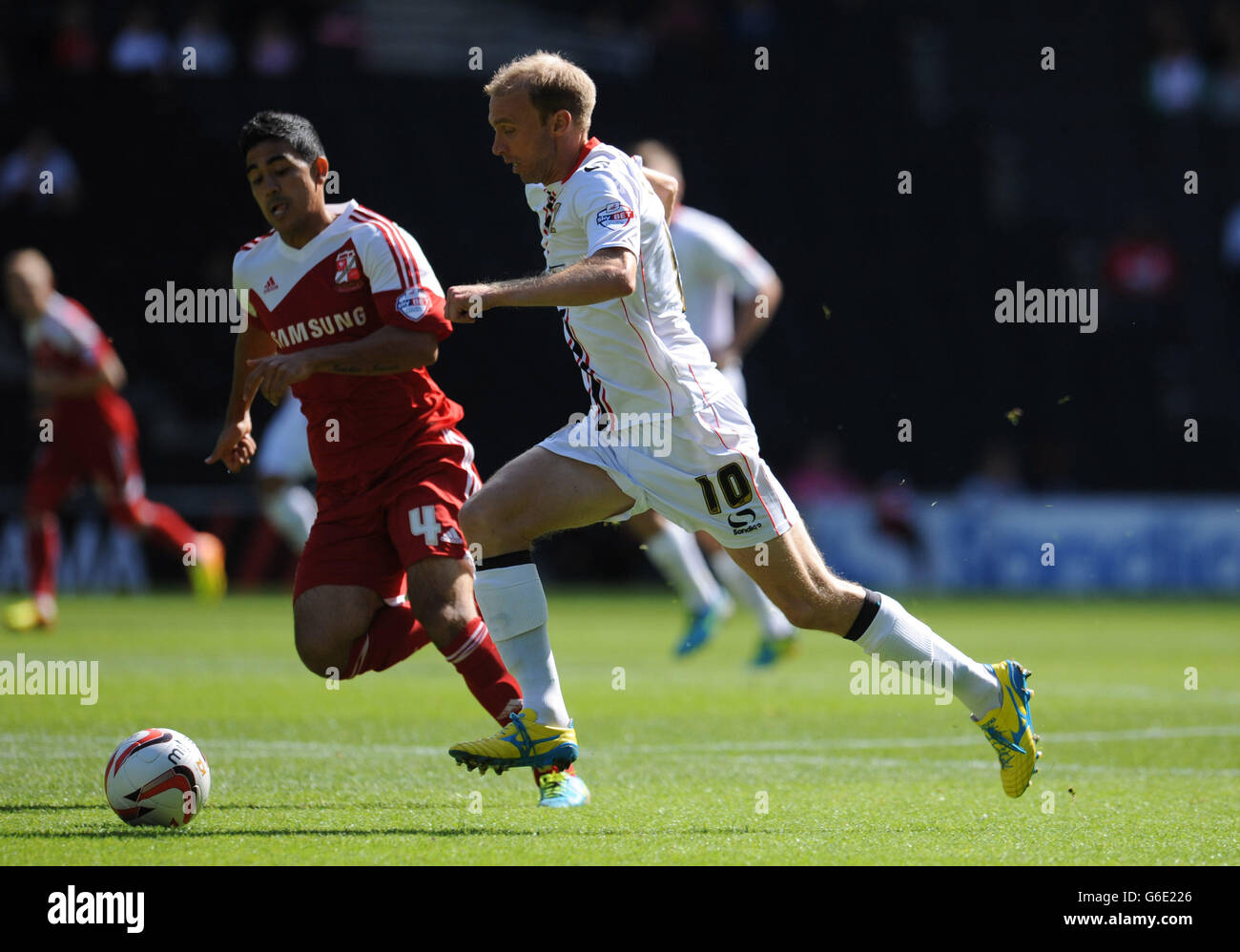 Swindon Town's Massimo Luongo and MK Don's Luke Chadwick during the Sky ...