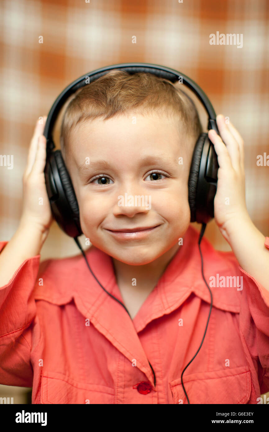 the child listens to music via earphones Stock Photo - Alamy