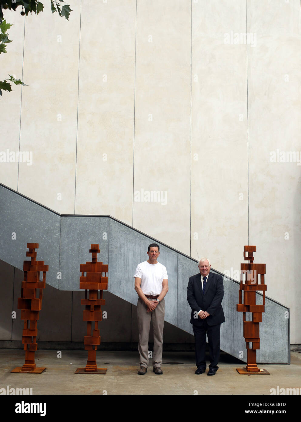 Sculptor Antony Gormley (left) stands next to one of his artworks at ...