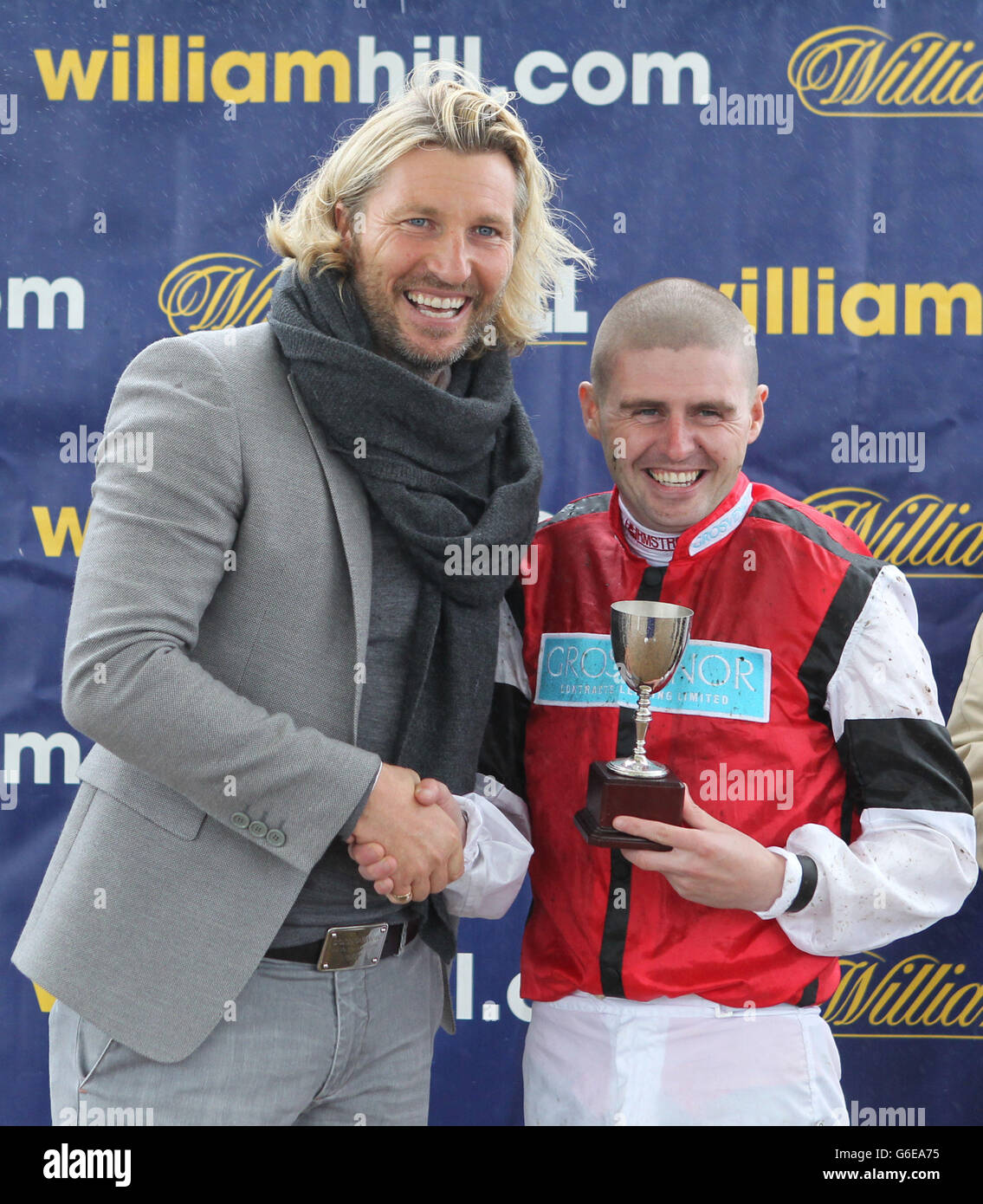Robbie Savage hands out a trophy to jockey Tony Hamilton who rode Hi ...
