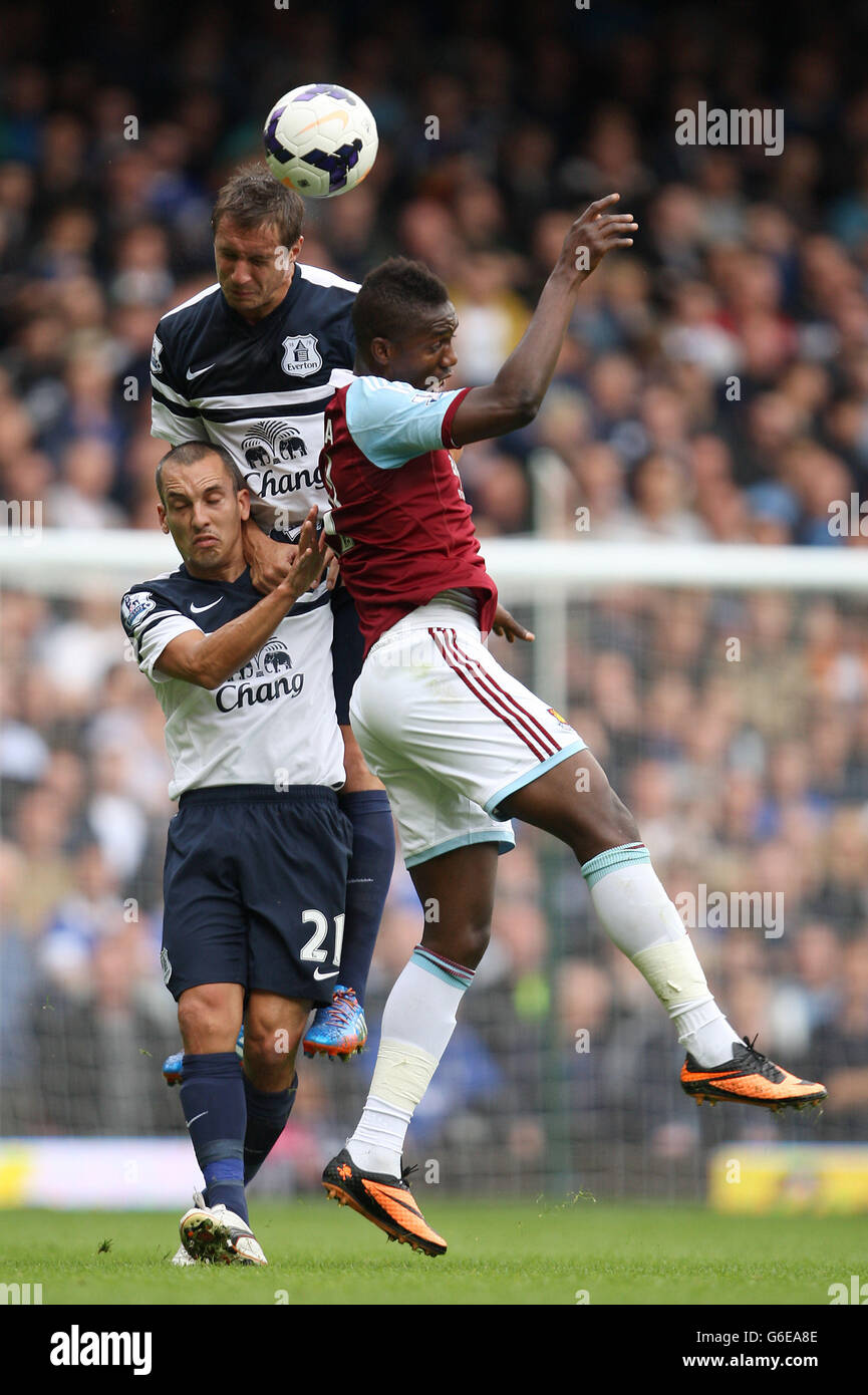 Everton's Phil Jagielka and Leon Osman compete for the ball with West ...