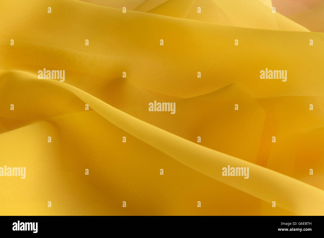 Shiny Yellow silky fabric Stock Photo - Alamy