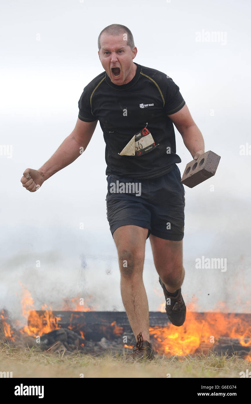 Participants tackle the fire obstacle during the Spartan Super Race at ...