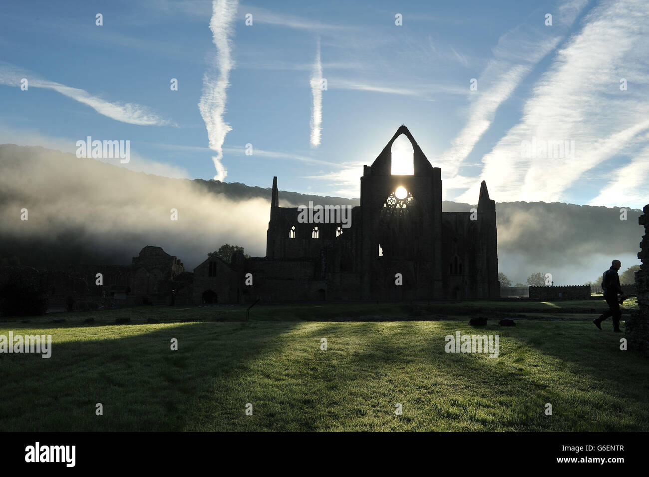 The Autumn sun rises behind Tintern Abbey in the Wye Valley Stock Photo ...