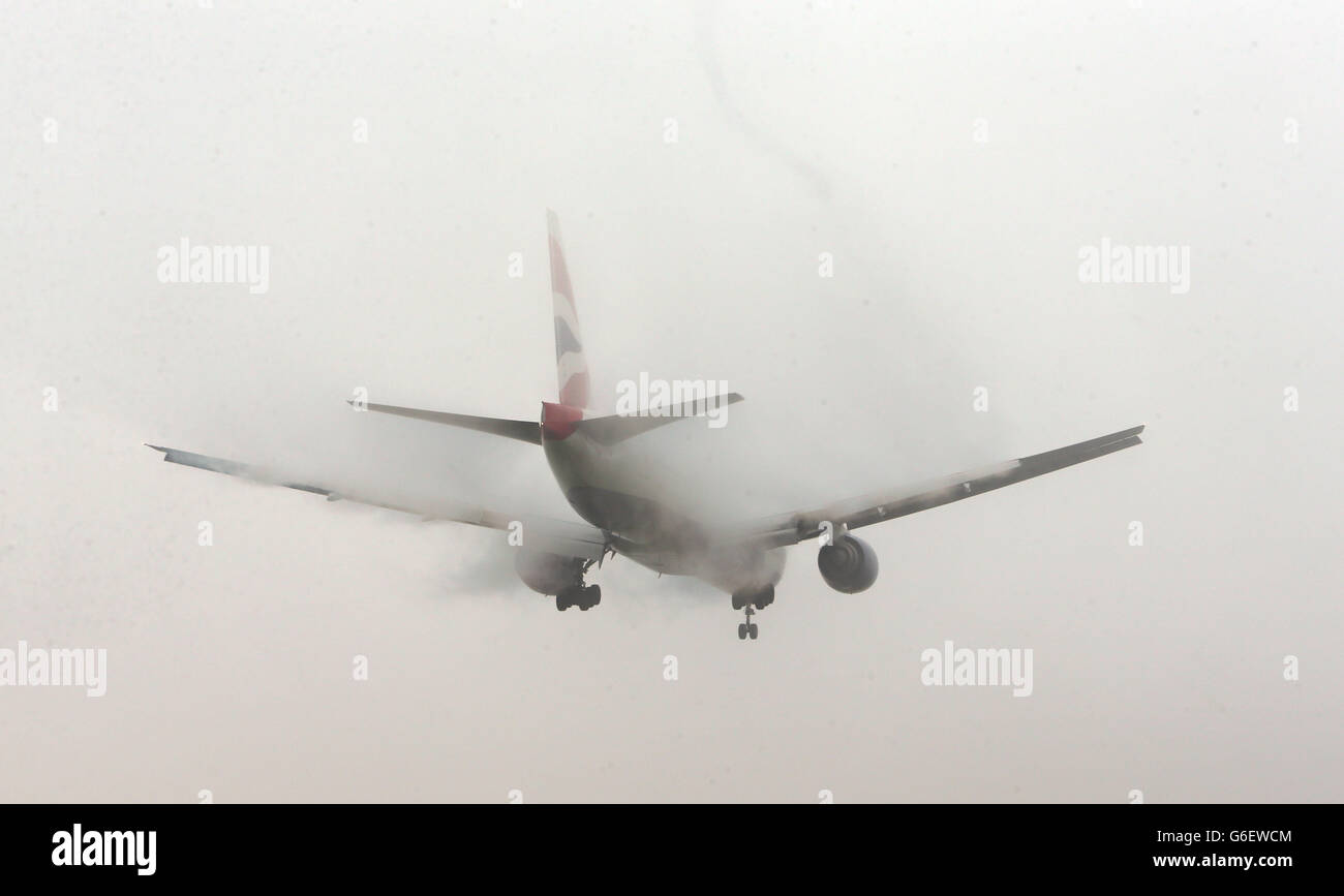 A British Airways planes lands in the fog at Heathrow Airport, London ...