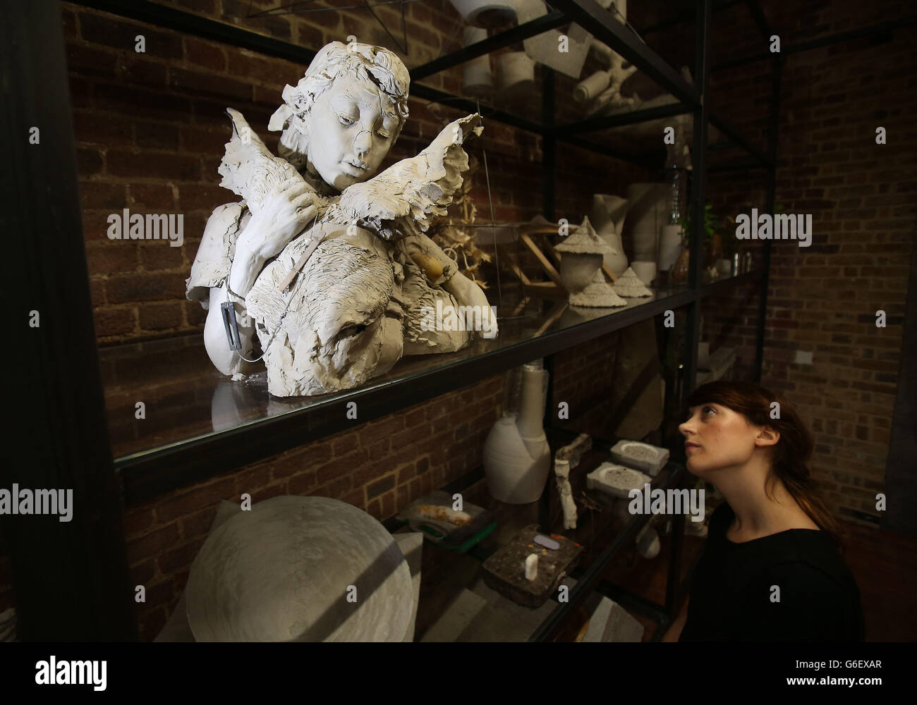 A visitor looks at a sculpture by Argentine artist Adrian Villar Rojas ...