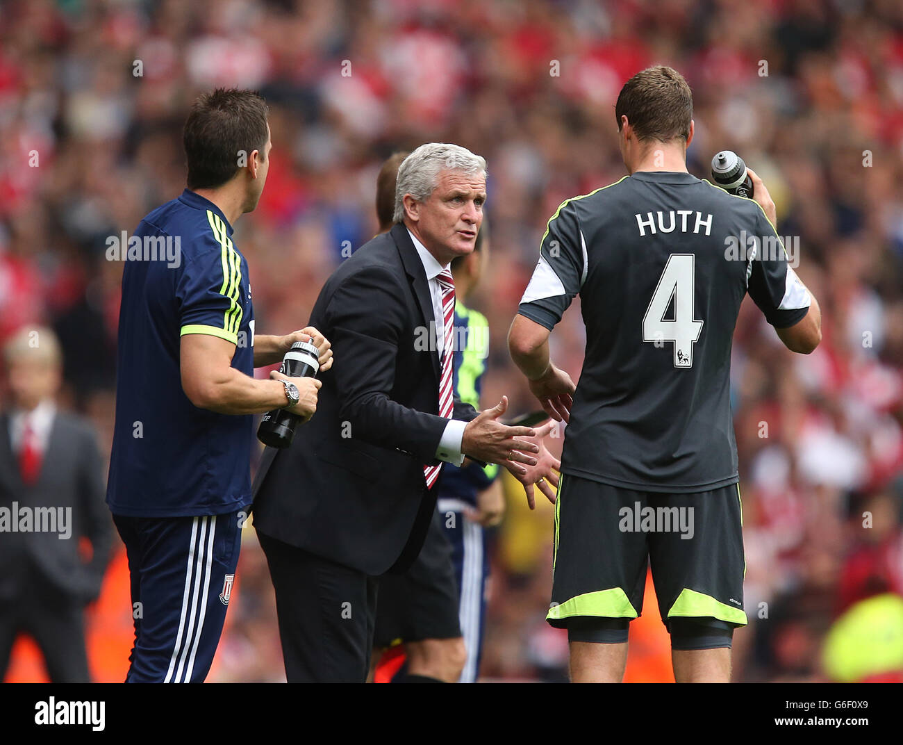 Stoke city manager mark hughes centre speaks with robert huth hi-res ...