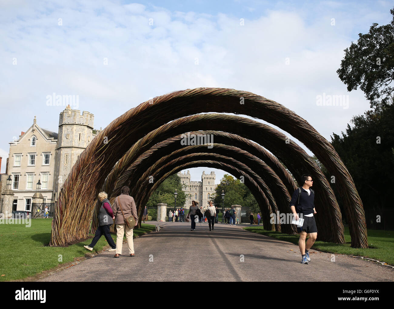People walk through a six-piece 9m (30ft) willow walkway planted on the ...