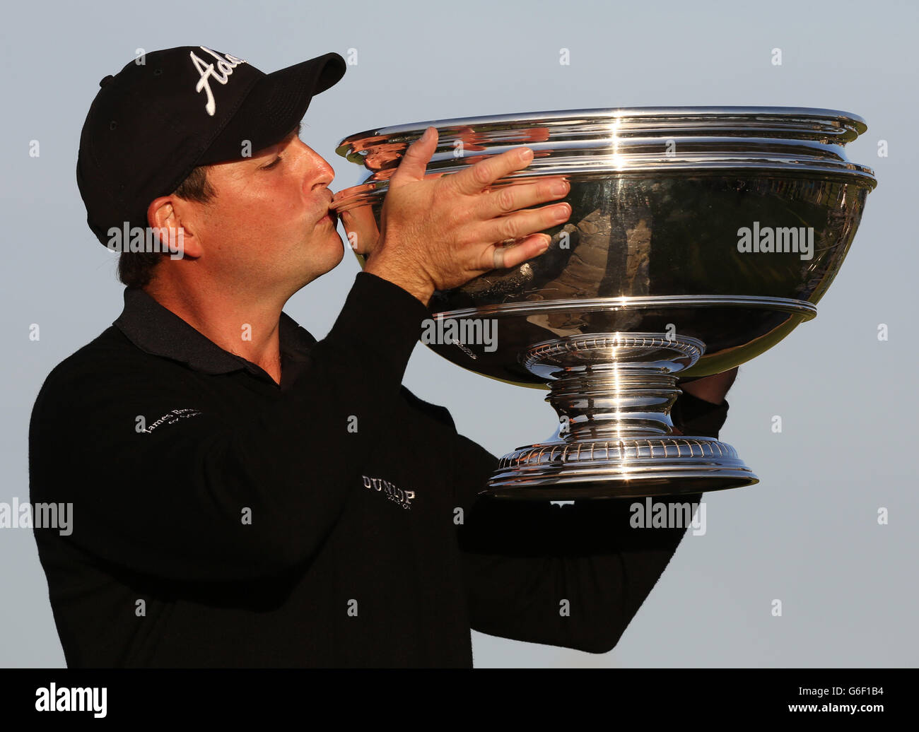 David Howell kisses the trophy after winning the 2013 Alfred Dunhill ...