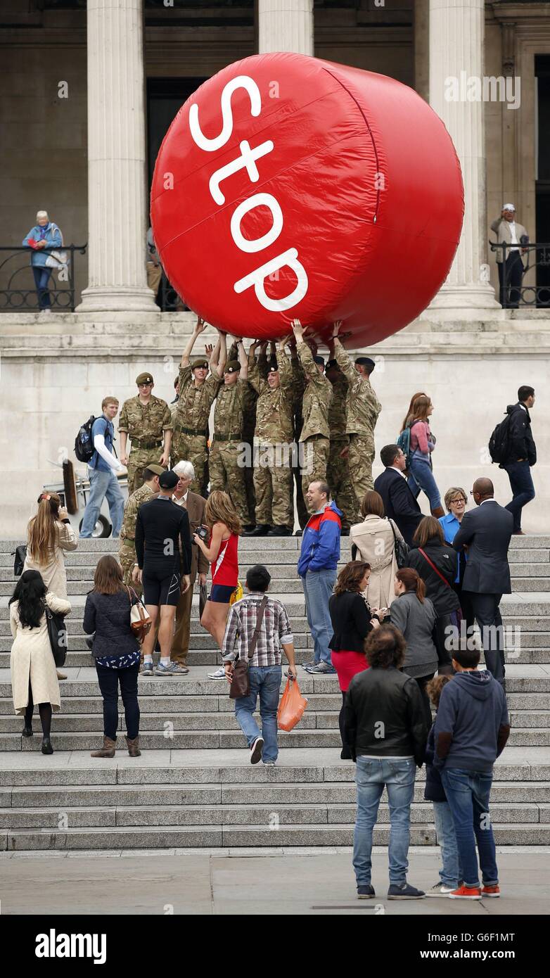 Soldiers carry an inflatable "stop" sign in Trafalgar Square, London ...