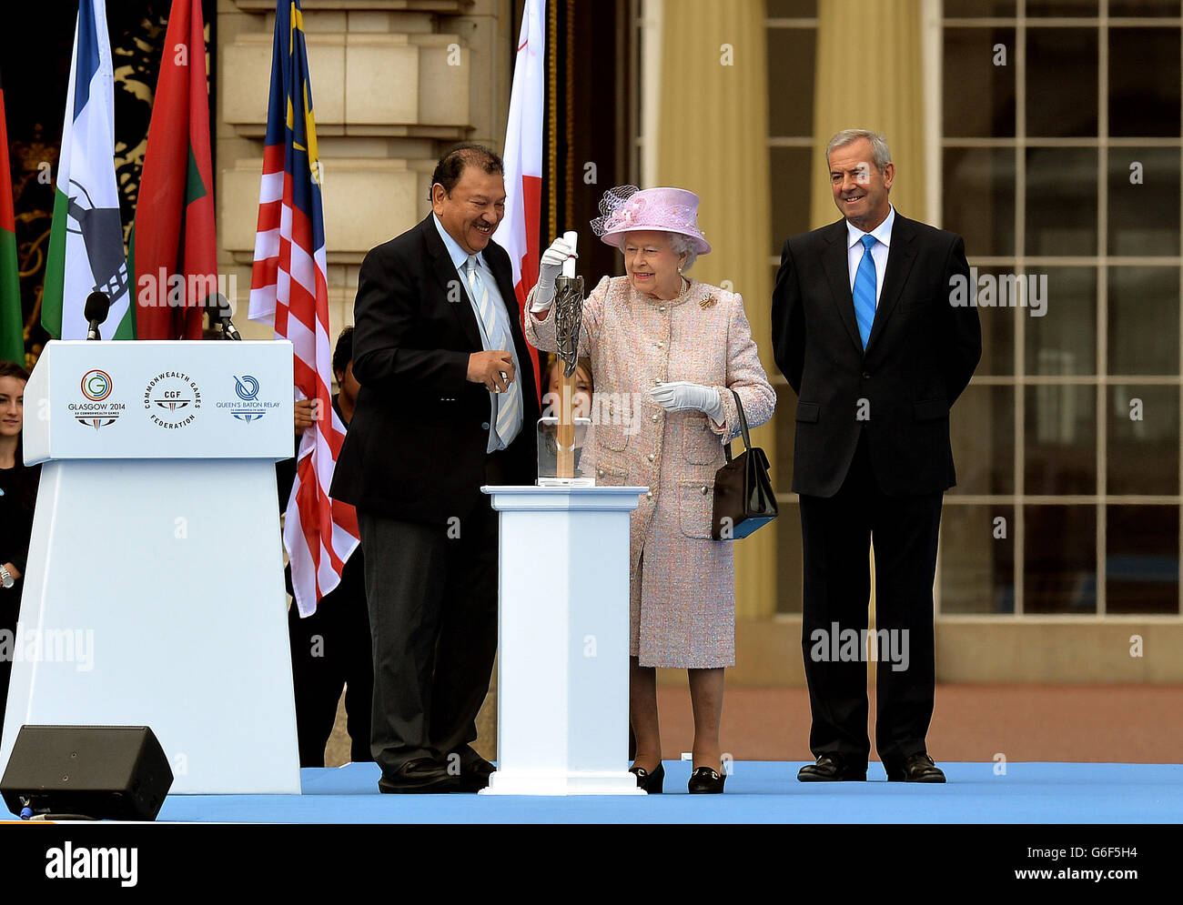 Queen Elizabeth II inserts a message into the Queen's Baton, in the ...