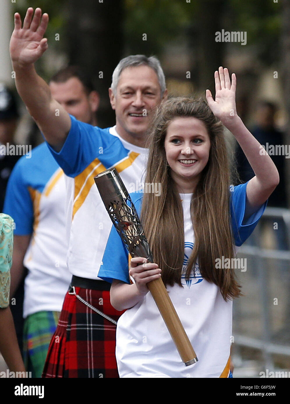 The Queen's Baton is carried along The Mall, London, during part of the ...