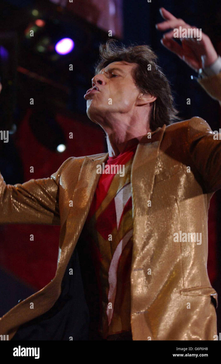 Lead singer Mick Jagger and the Rolling Stones performing on stage ...