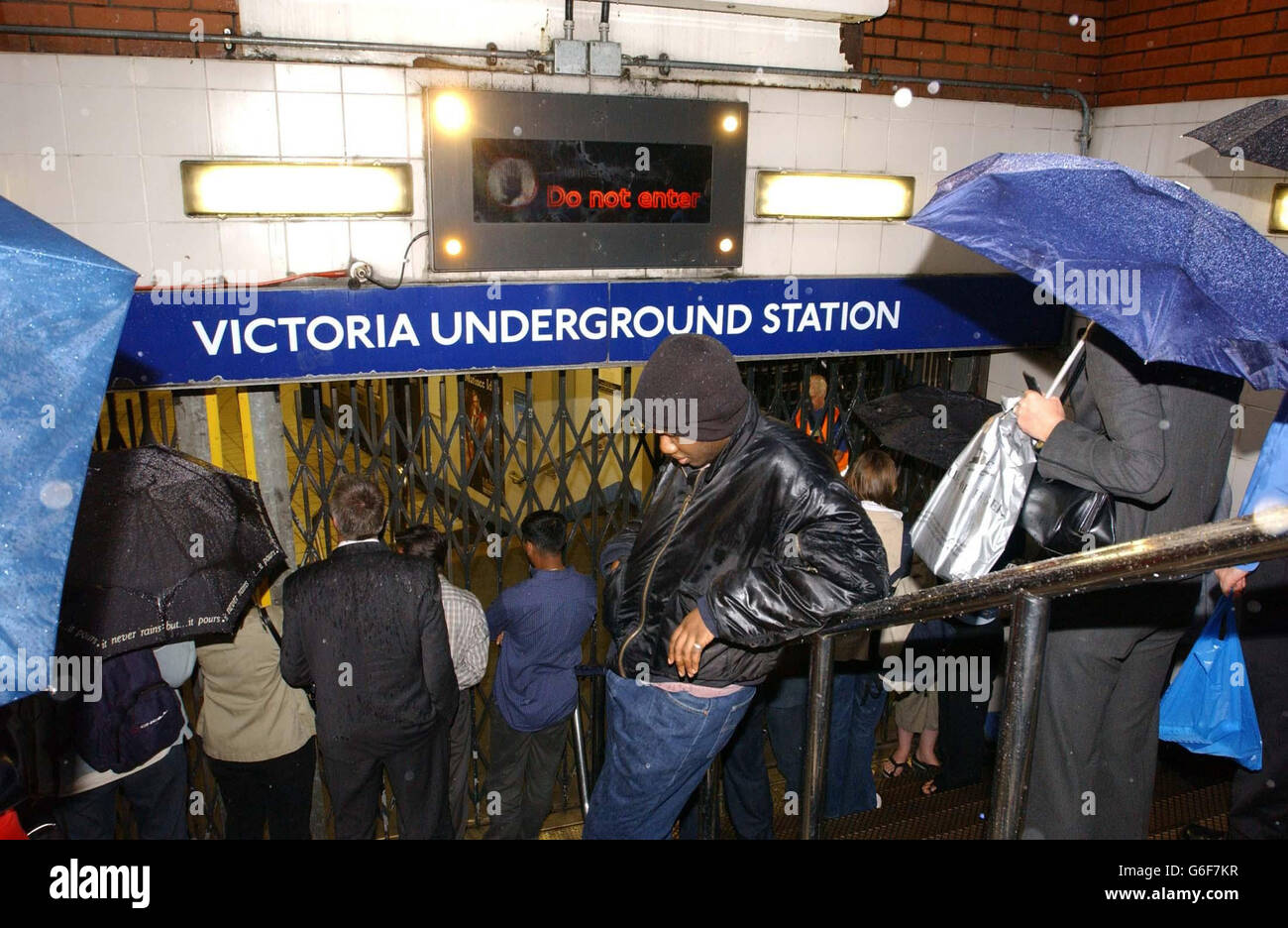 Travellers wait outside a closed Victoria Underground station after a ...