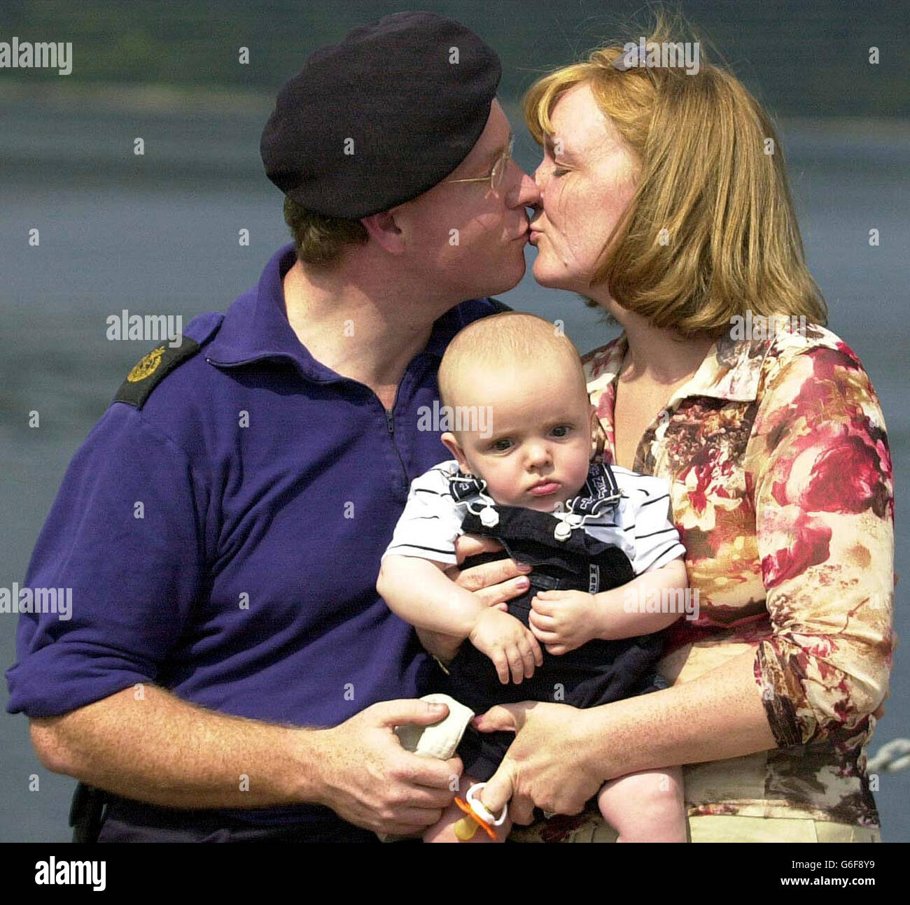 Chief Petty Officer, Paul Wain, greets his wife Sheena and 19-week-old ...