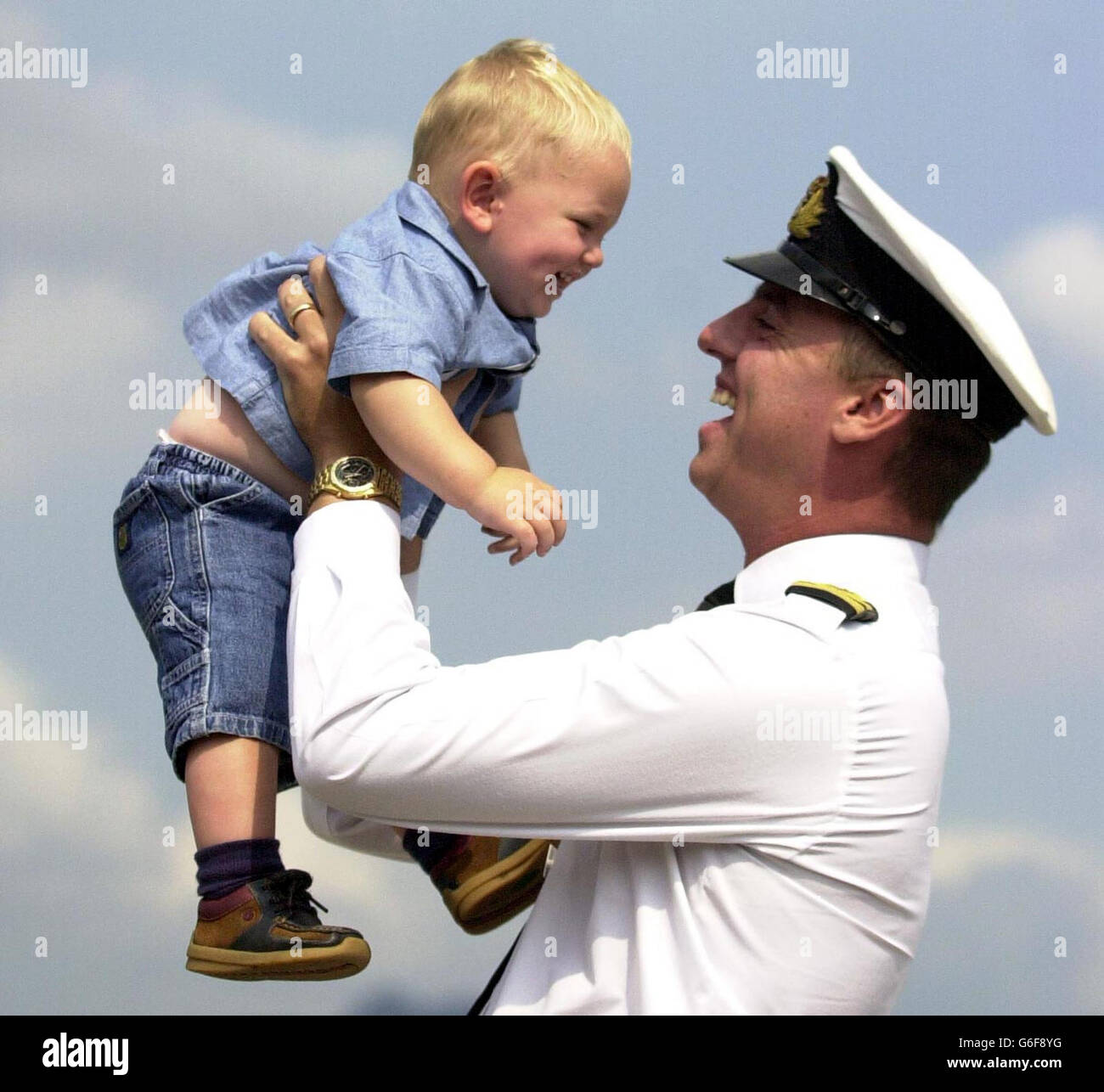 Tactical Systems officer, John Livesey, greets his 16-month-old son ...