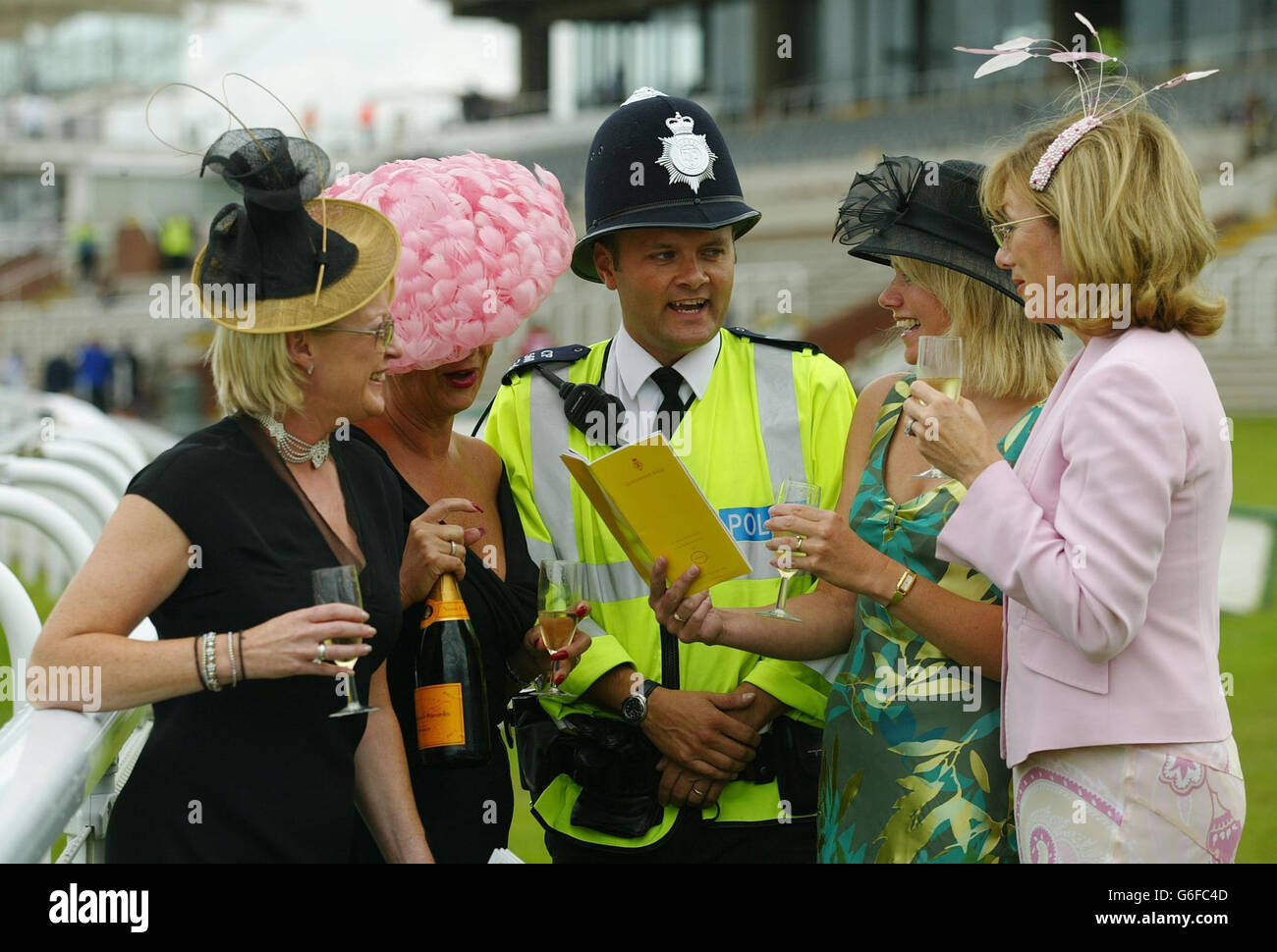 A police officer helps Goodwood members (left to right) Joyce Wormull ...