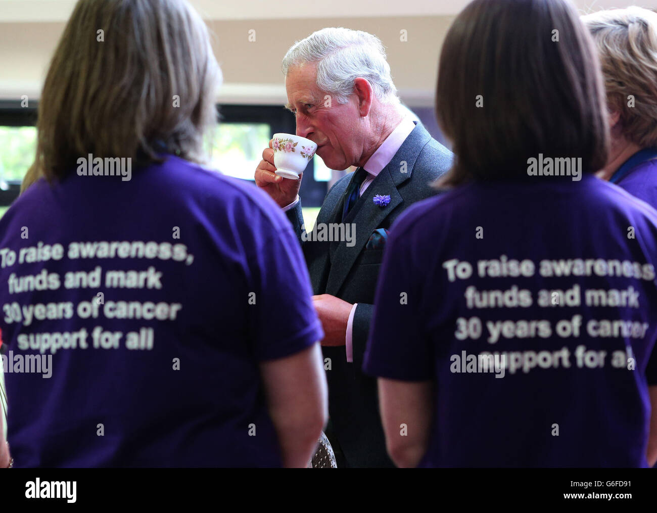 The Prince of Wales speaks with volunteers during a tour of CLAN Cancer ...