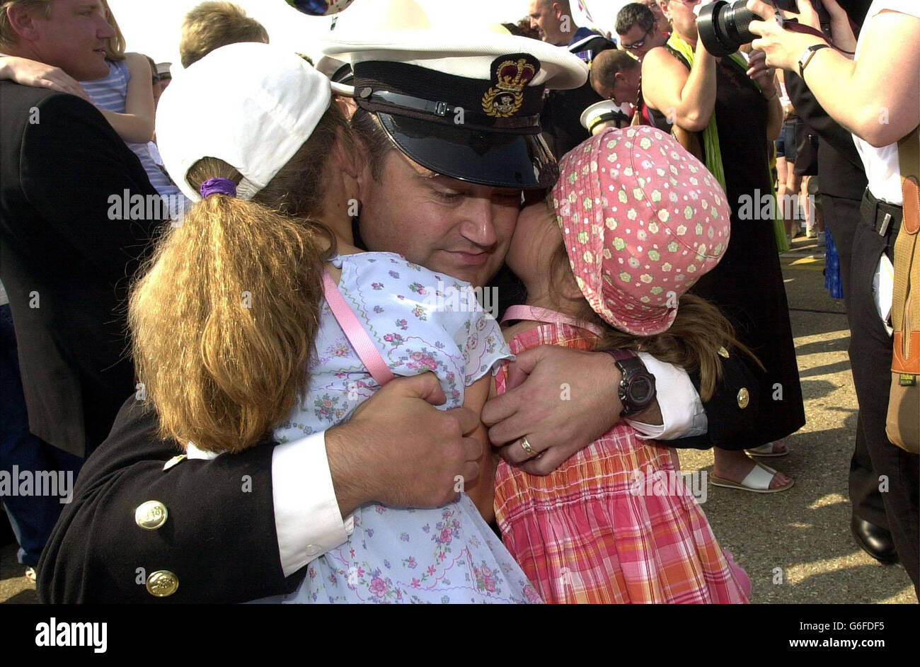 Chief Petty Officer Andrew Weeks of HMS Liverpool hugs his children ...