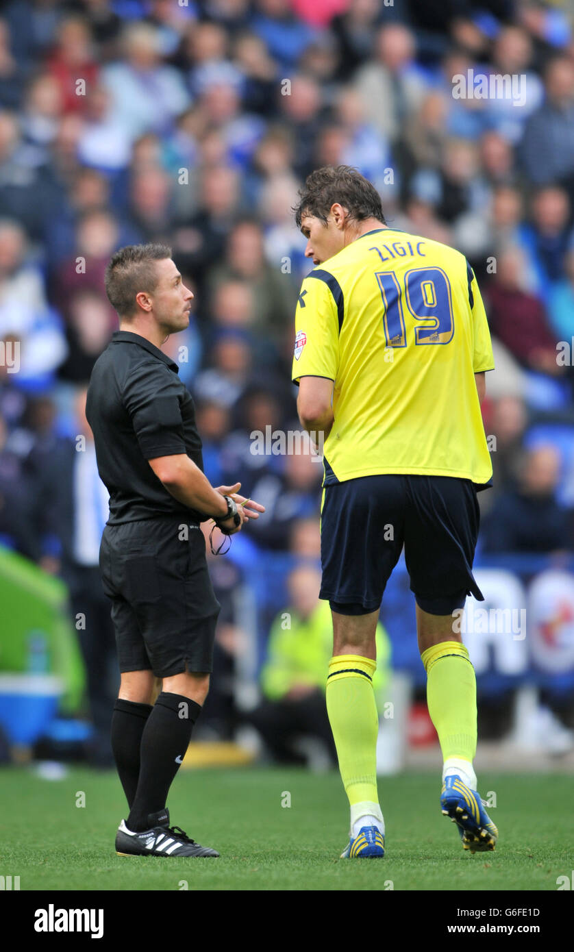 Birmingham City's Nikola Zigic (right) looks down on referee James ...