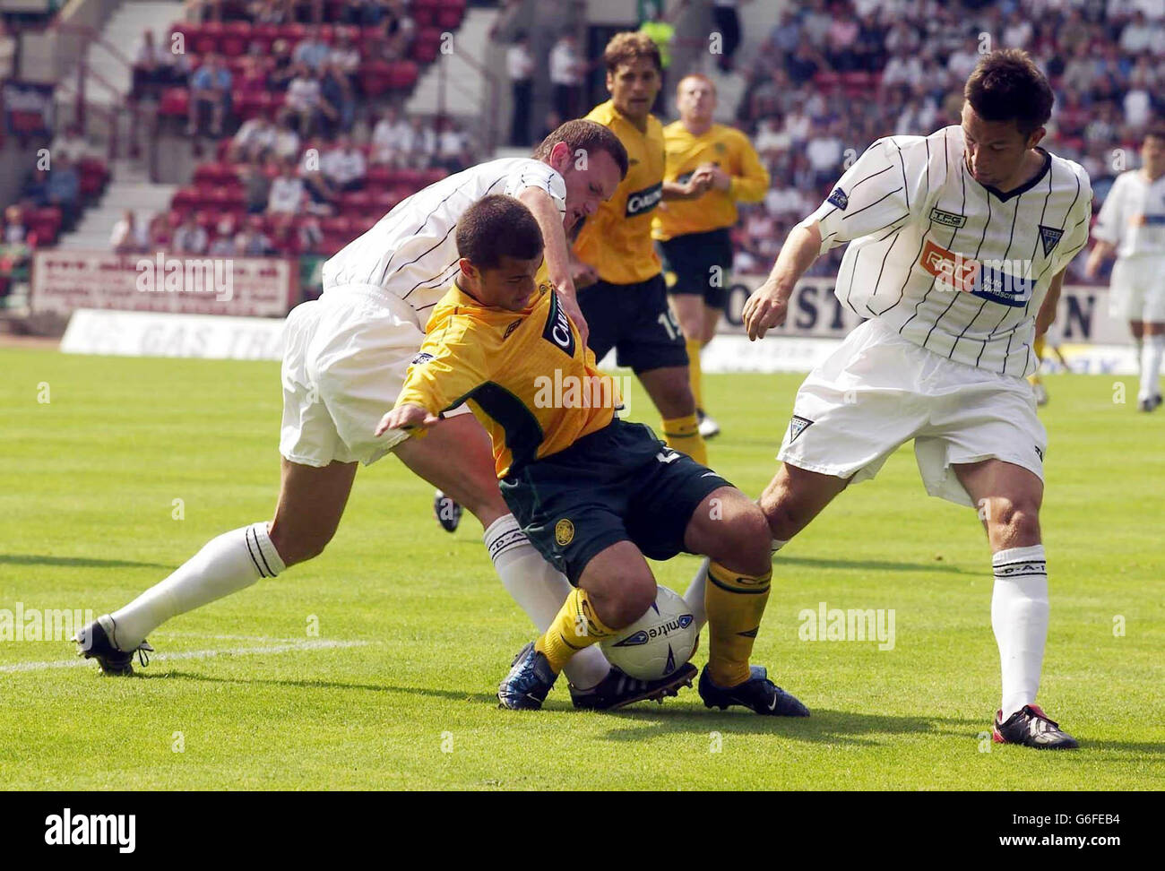 Dunfermline's Scot Wilson (left) and Barry Nicholson (right) stops ...
