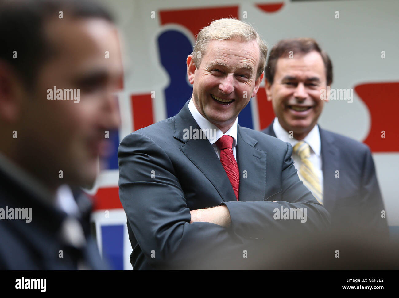 Taoiseach Enda Kenny and Alan Shatter listen to a journalist record a ...