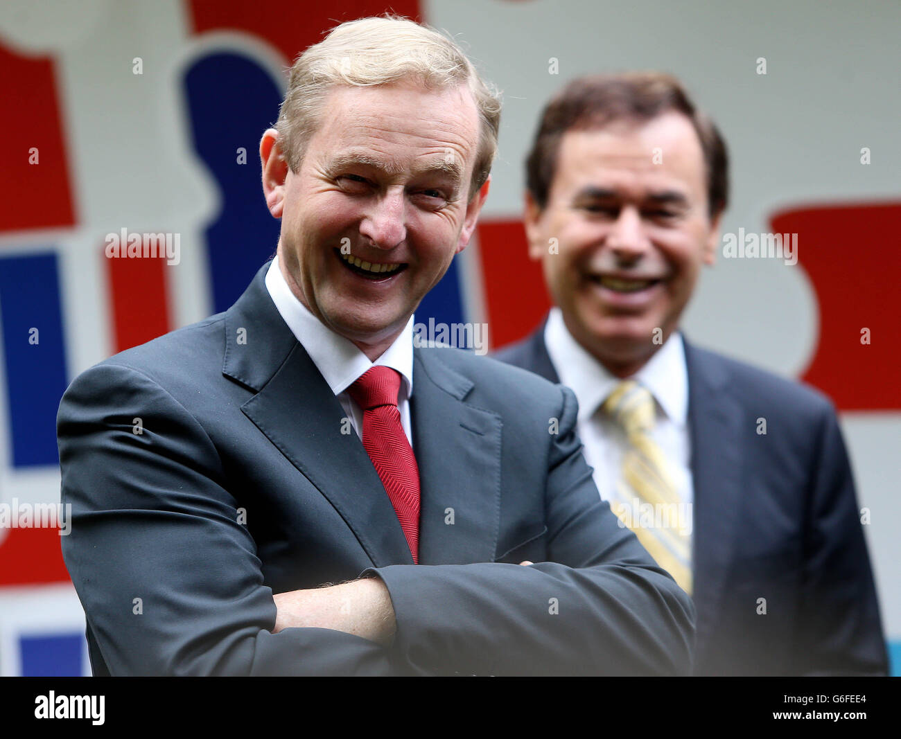 Taoiseach Enda Kenny and Alan Shatter listen to a journalist record a ...