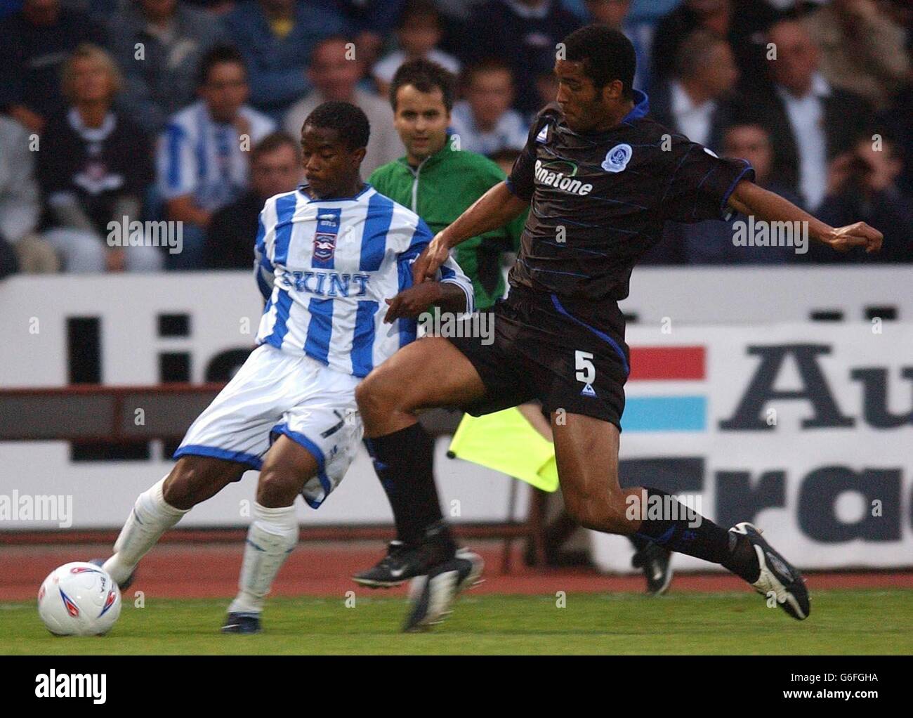 Leon Knight (left) of Brighton takes on Clarke Carlisle of Queen's Park ...