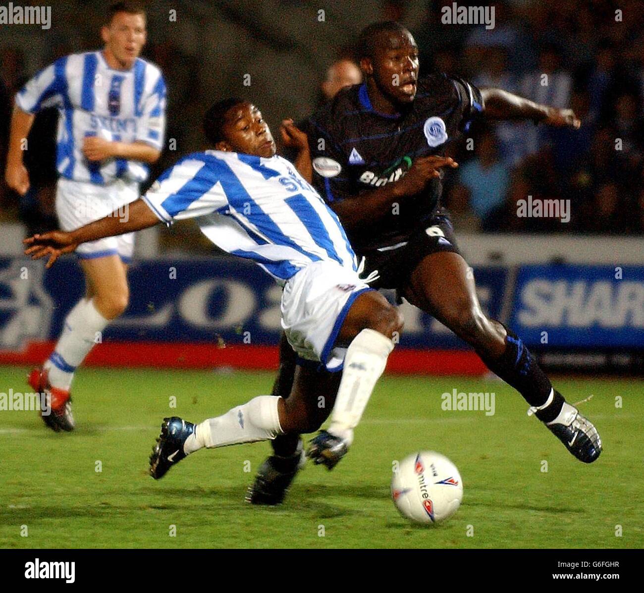 Leon Knight of Brighton slides past Daniel Shittu of Queens Park ...