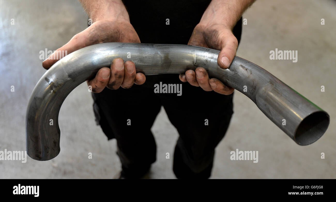Car Repair Stock. A Mechanic poses with a piece of stainless Steel ...