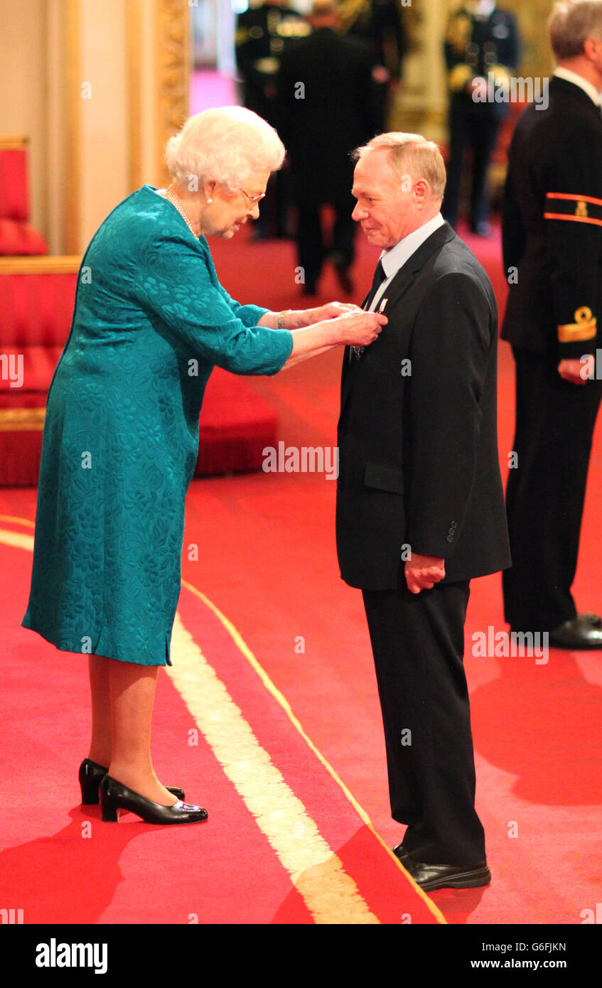 Trevor Spence receives an MBE from Queen Elizabeth II at an Investiture ...