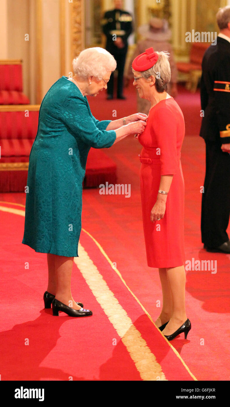 Receives an mbe from the queen at buckingham palace hi-res stock ...