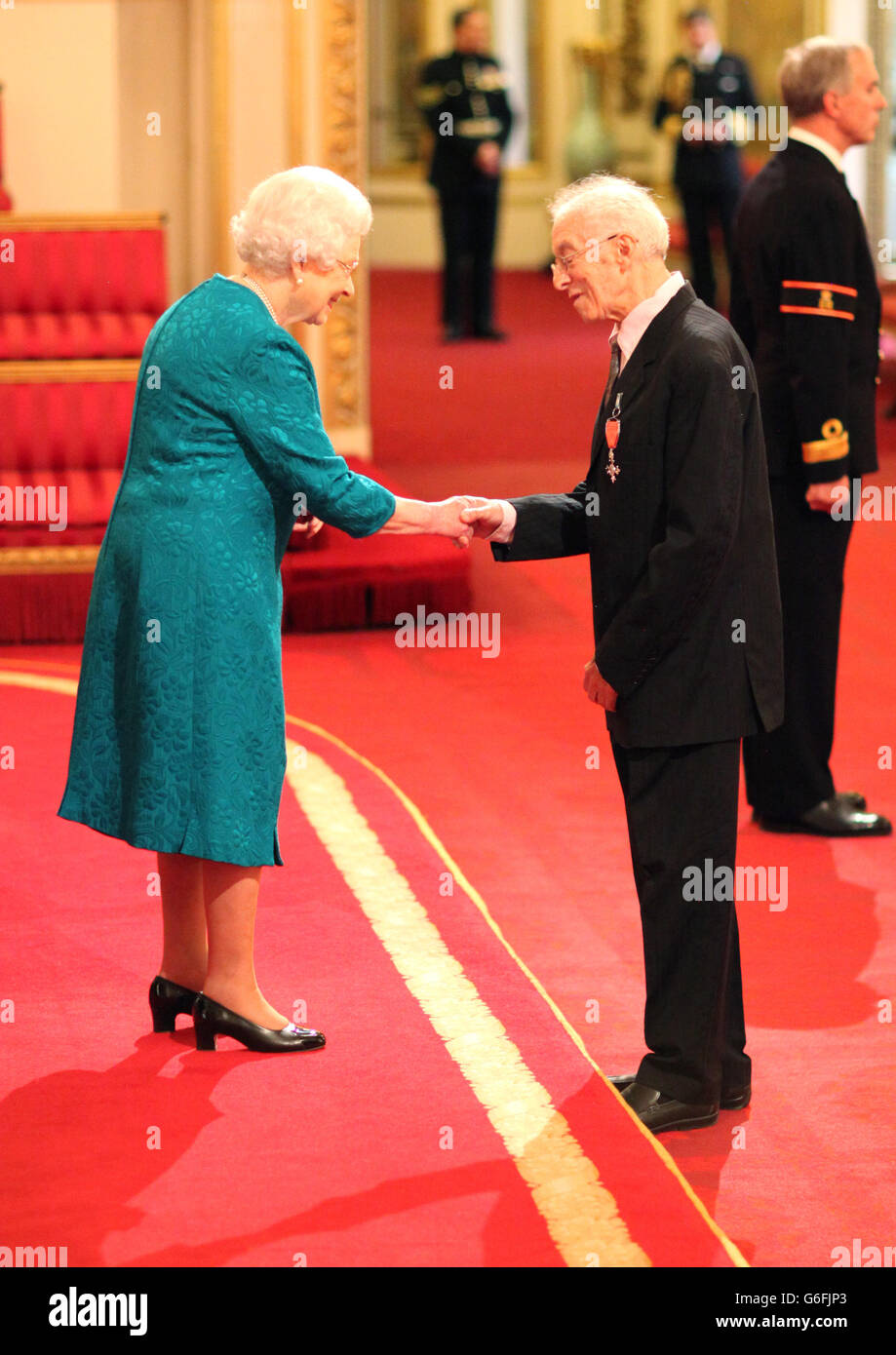 Receives an mbe from the queen at buckingham palace hi-res stock ...