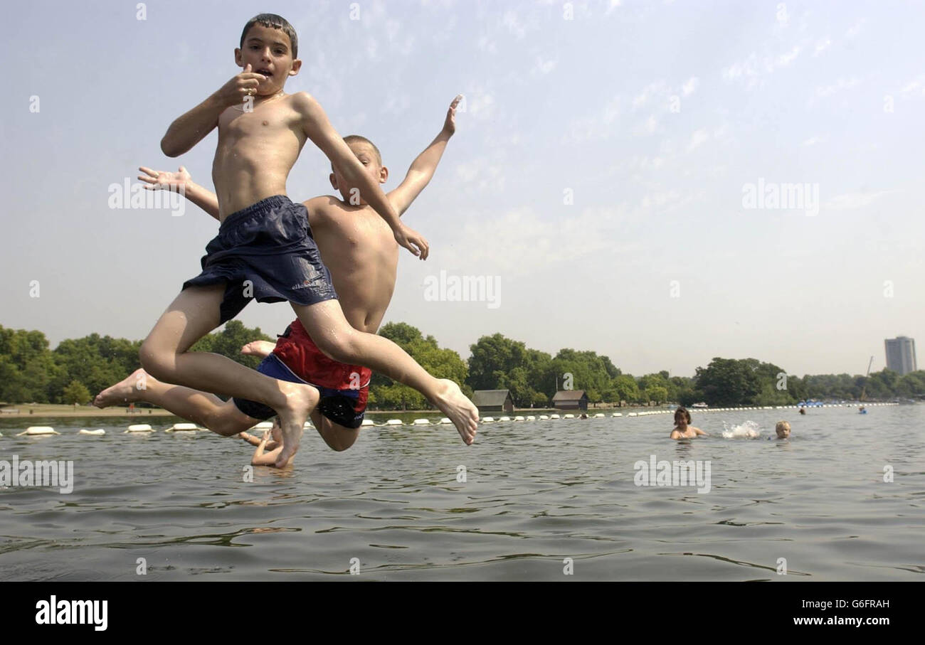 Two boys leap into the water at Hyde Park Lido, central London, to cool ...