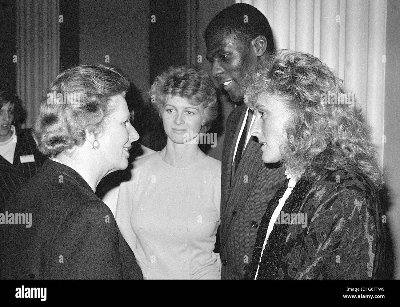 Margaret Thatcher talks to three athletes at a reception for the Sports ...