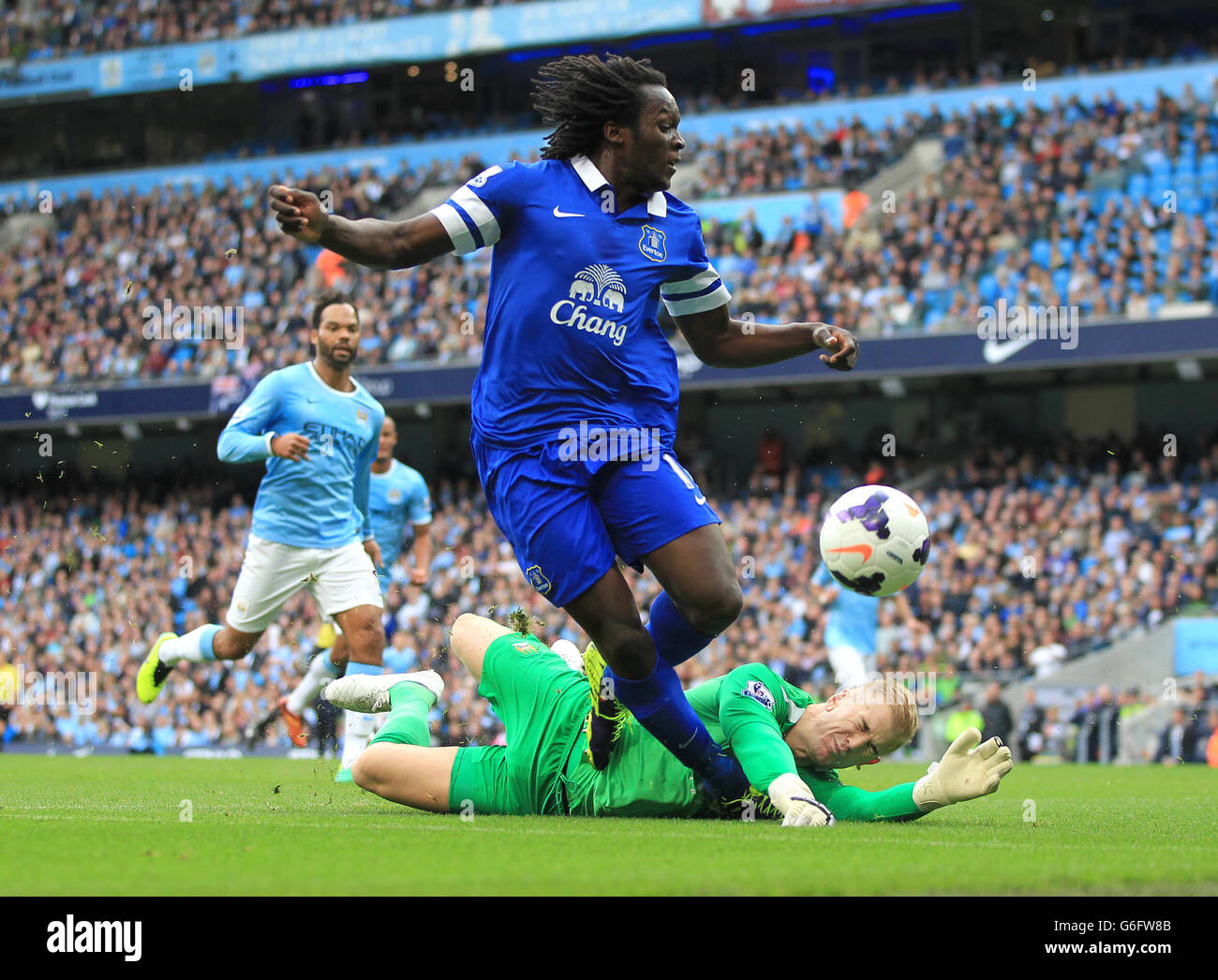 Manchester City goalkeeper Joe Hart (bottom) dives to save a shot from ...