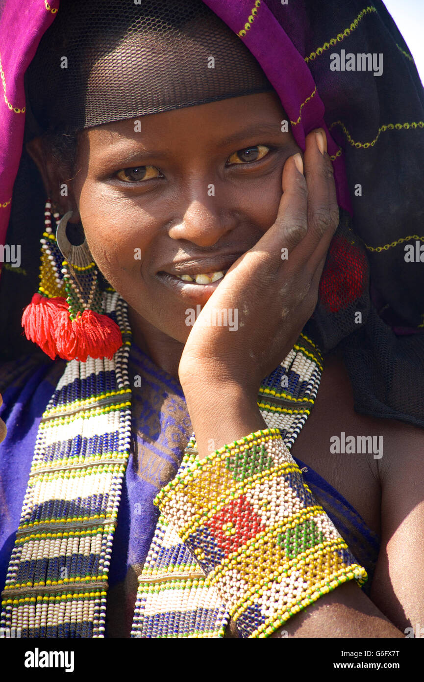 Afar woman in tribal dress, passing through Yangudi Rassa National Park ...
