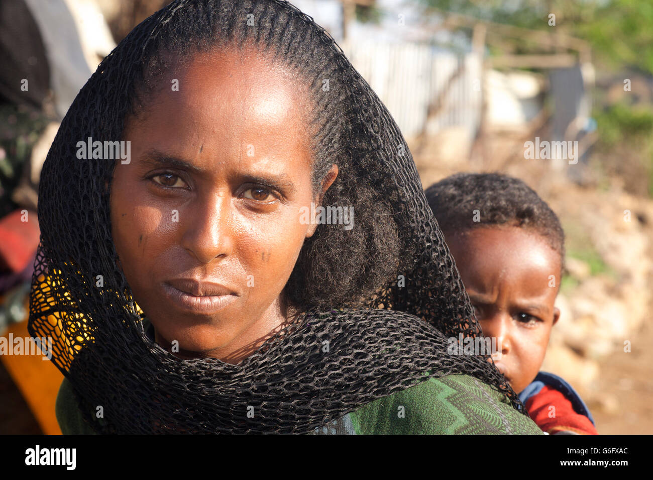 Portrait of an Oromo mother with child with scarification and stylised ...
